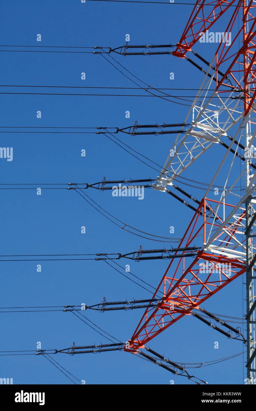 Red white power pole, high-voltage pole, with transmission lines ...