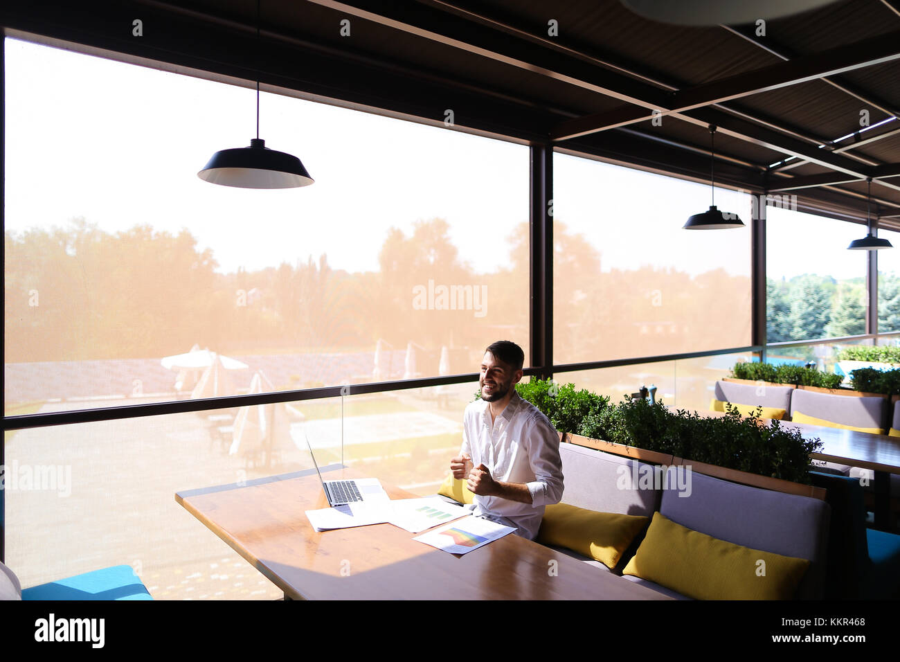 Lucky successful manager working with laptop and documents with ...