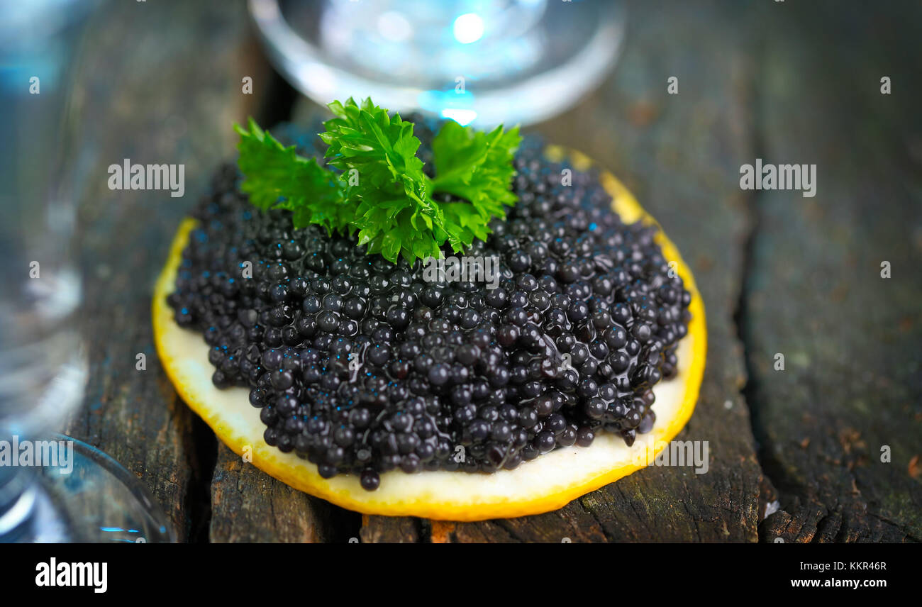 Caviar on lemon Stock Photo - Alamy
