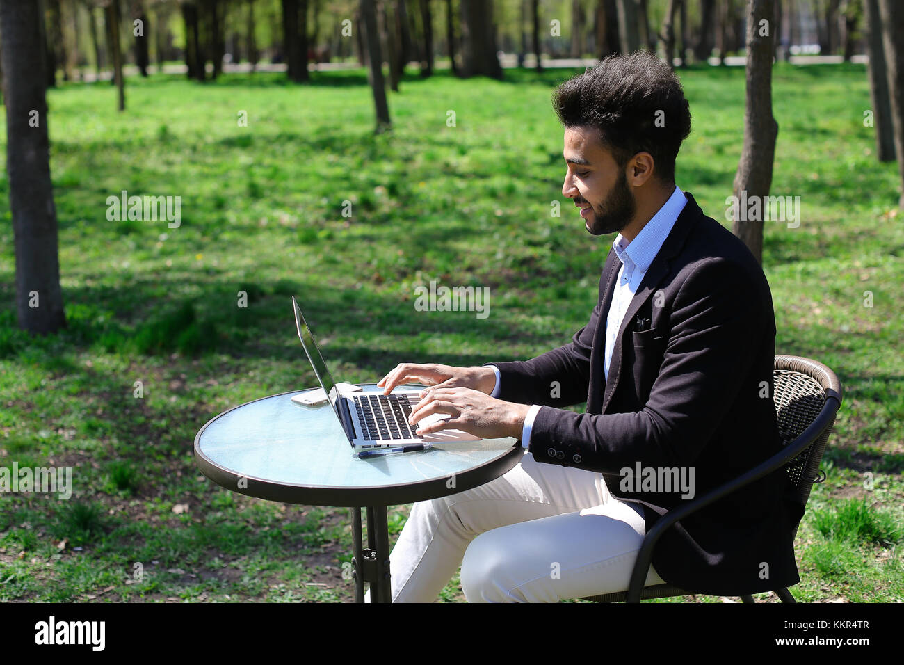 Handsome person using laptop and clicking keyboard, putting hands up ...
