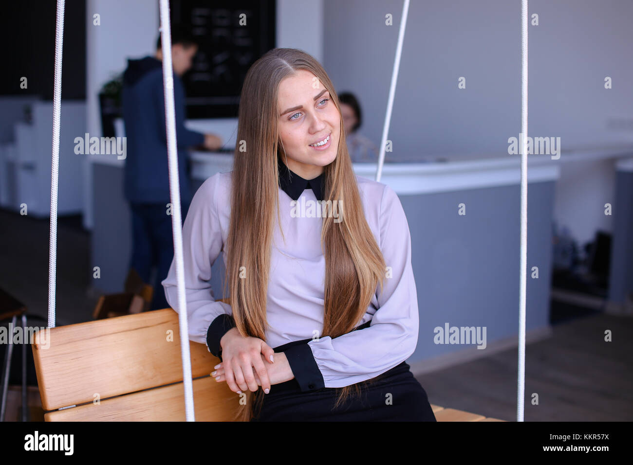 Portrait of cute long-haired successful secretary girl who poses on ...