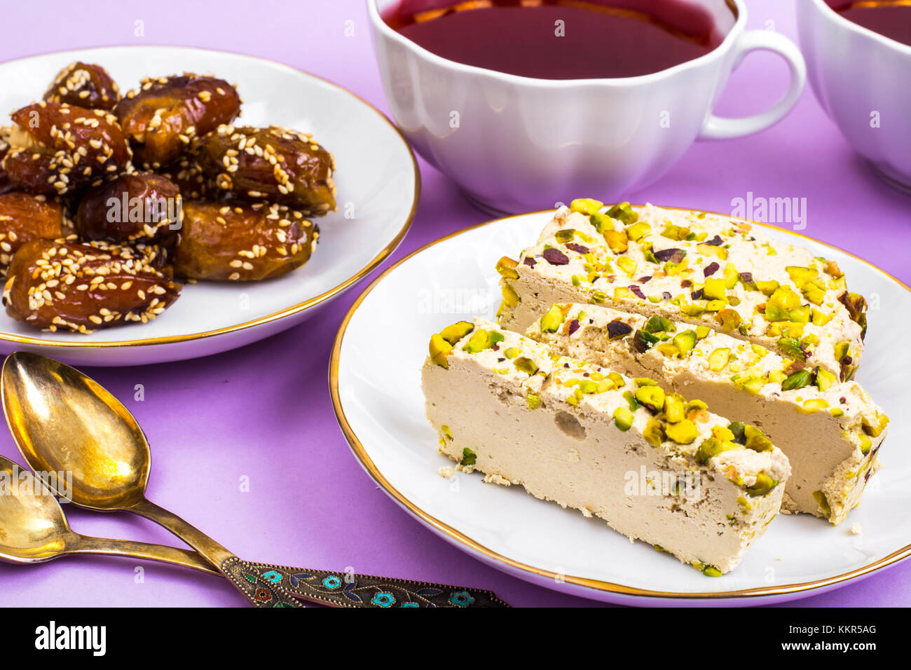 Oriental sweets-halva and dates on bright pink background Stock Photo ...