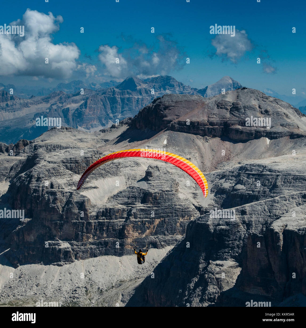 Dolomites, paraglider above cliff faces of the Sella group, Piz Selva ...