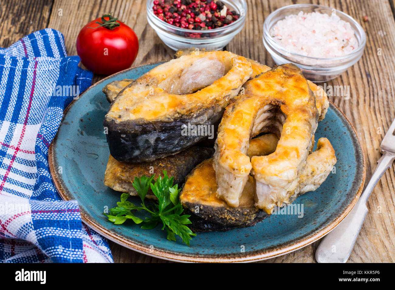 Pieces of fried fish on blue plate Stock Photo - Alamy