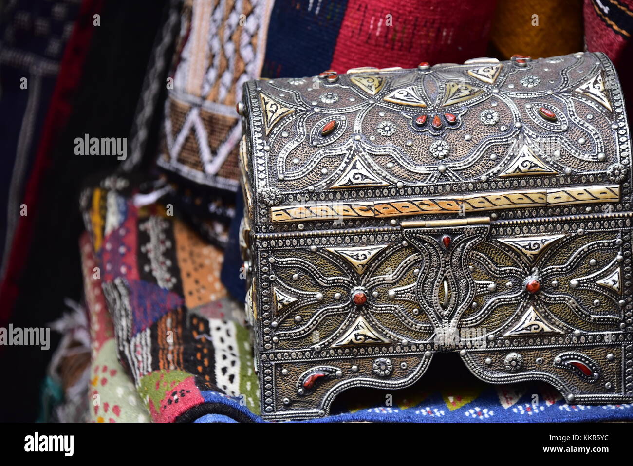 Ornate silver trinket box with colorful textiles on sale in a Moroccan ...