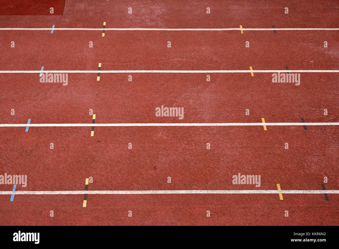 Close up diagonal perspective to 100 track in stadium with markings hi ...