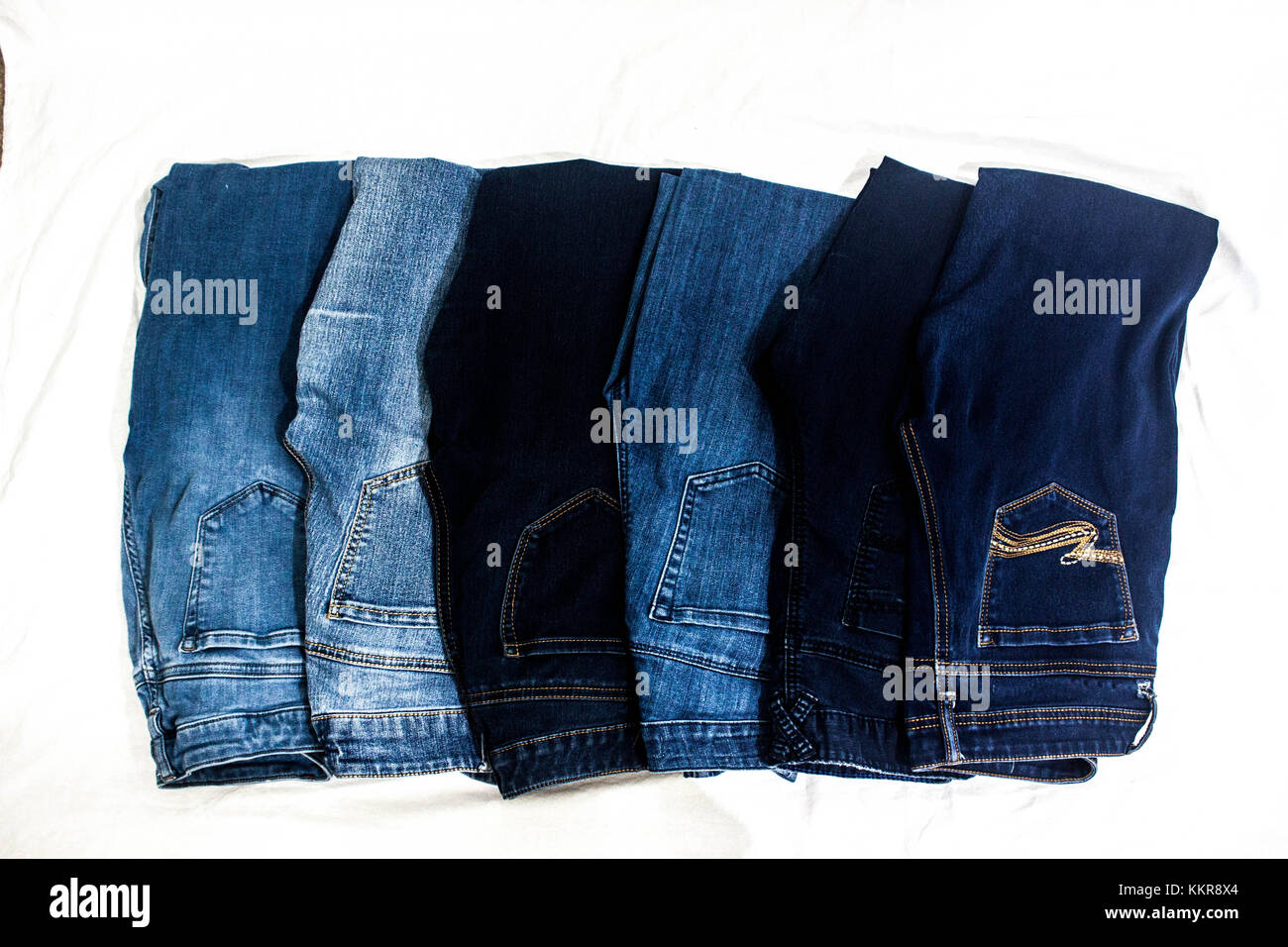 A Spread of Various Colors of Blue Jeans Stock Photo - Alamy