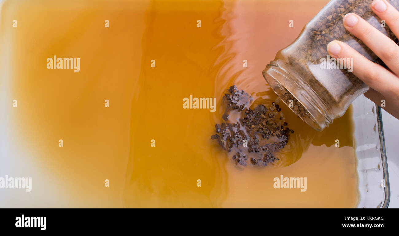 Coffe slowly dissolve in the hot water Stock Photo - Alamy