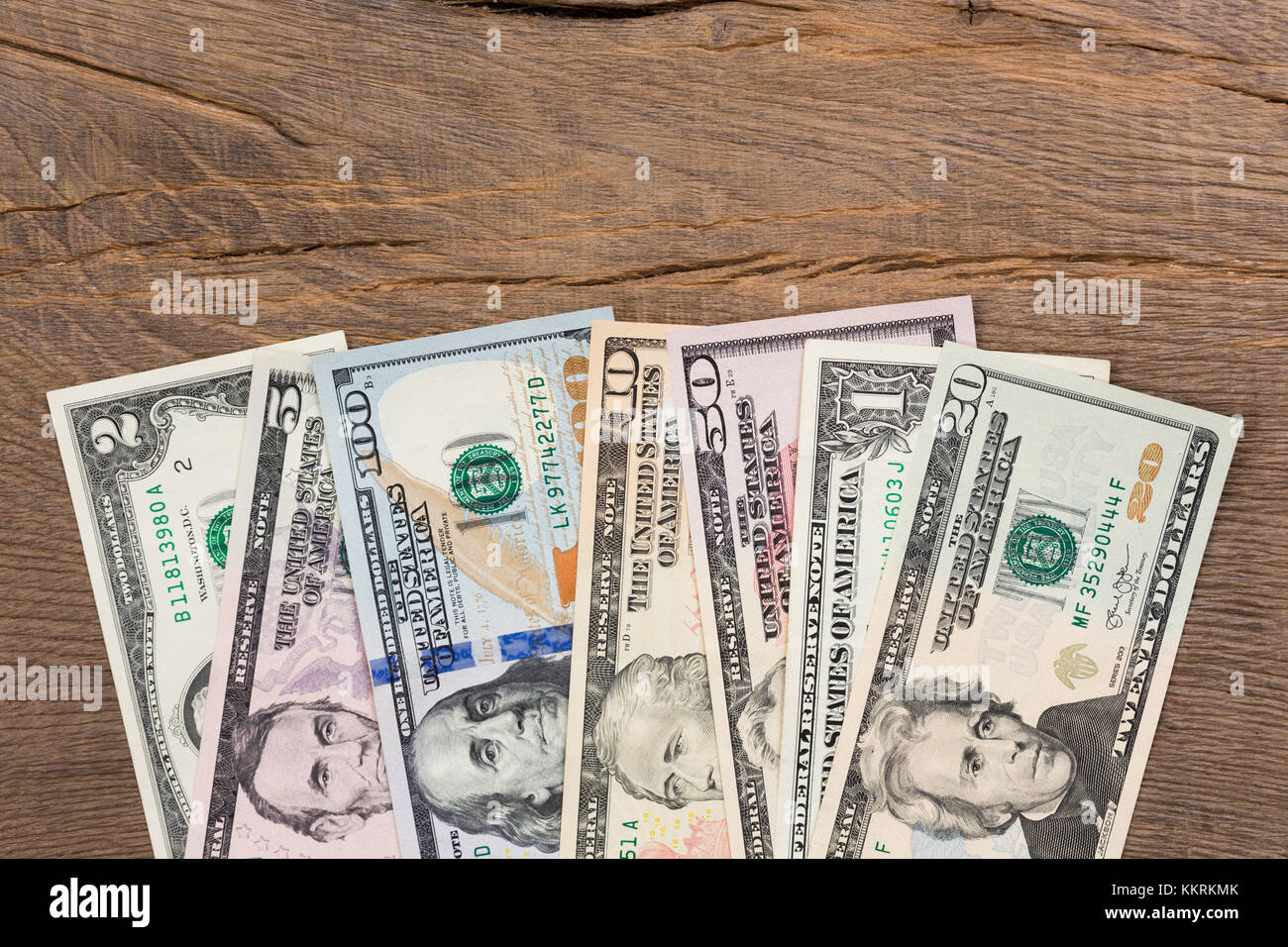 Lots of dollar bills on wooden background Stock Photo - Alamy