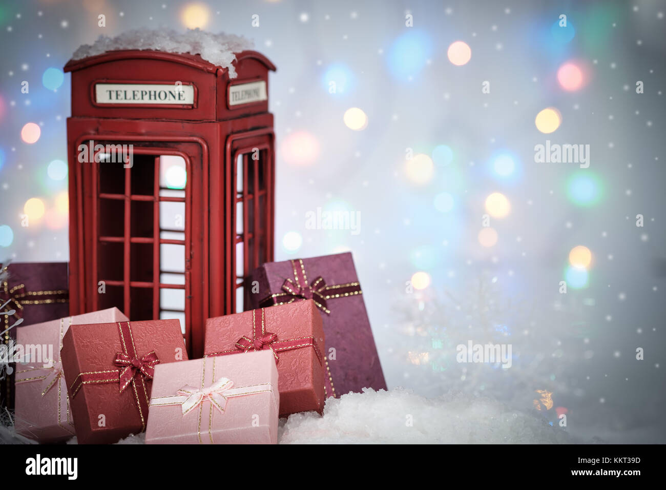 Red gift boxes and phone box on snowfall background with copy space for ...