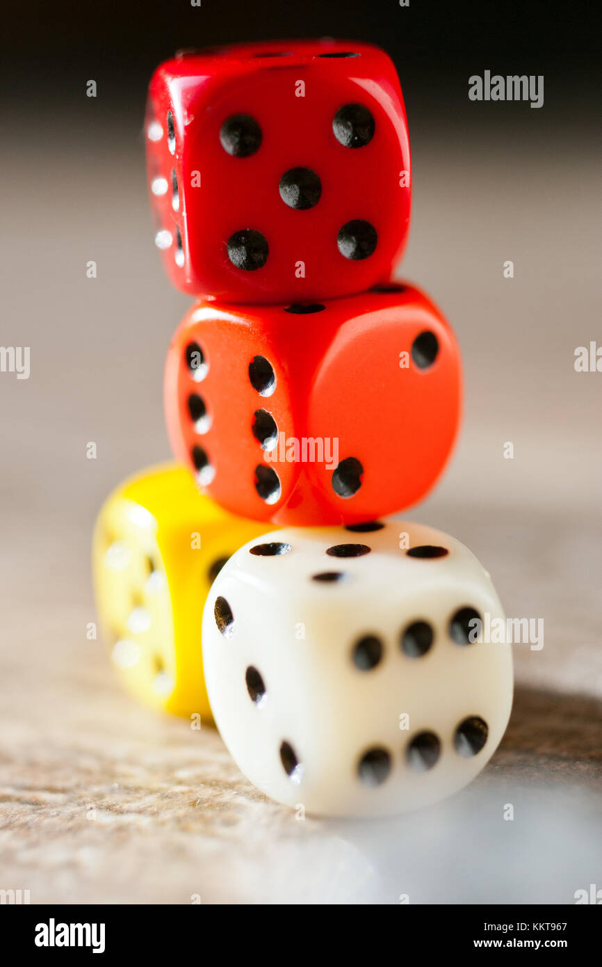 Playing dices on the table -various colors Stock Photo - Alamy