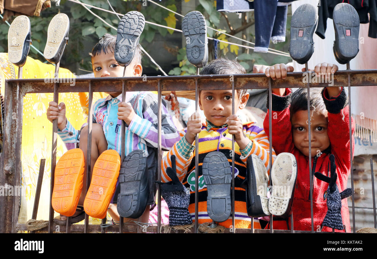 The fun a gate can provide: The children were seen hanging off a gate ...