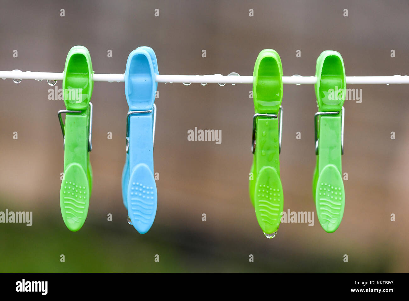 conceptual image of a rainy day still life with wet peg in the yard ...