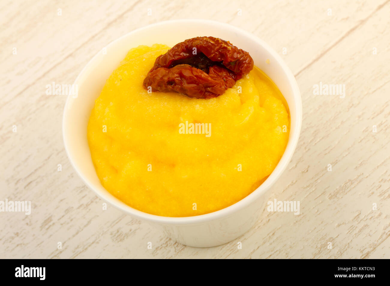 Polenta with dry tomato Stock Photo - Alamy