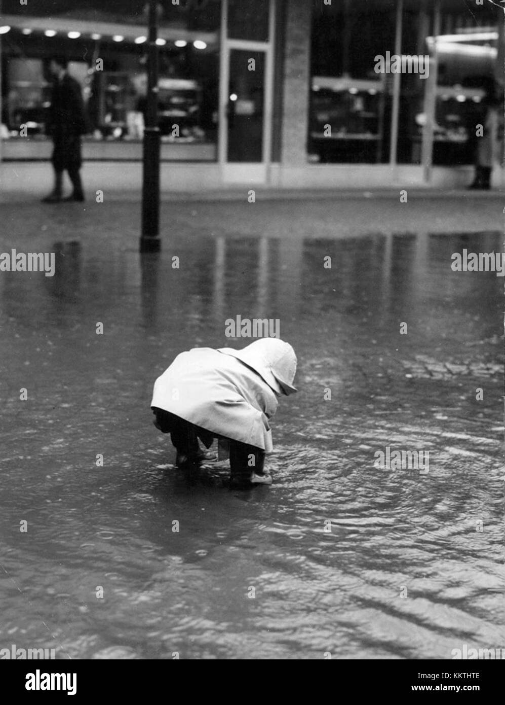 A child standing and looking for something in water 391751964887 Stock ...
