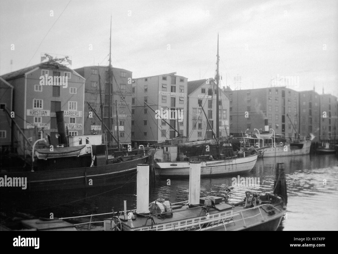 A photograph depicting boats in the harbor of Trondheim, Norway. The ...