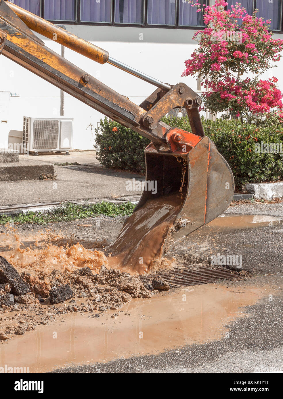 Excavator working on the Repair of pipe water and sewerage on road ...
