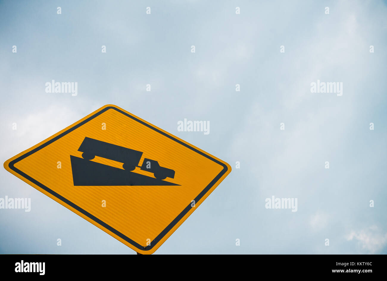 Yellow Steep truck slope traffic sign with cloudy sky Stock Photo - Alamy