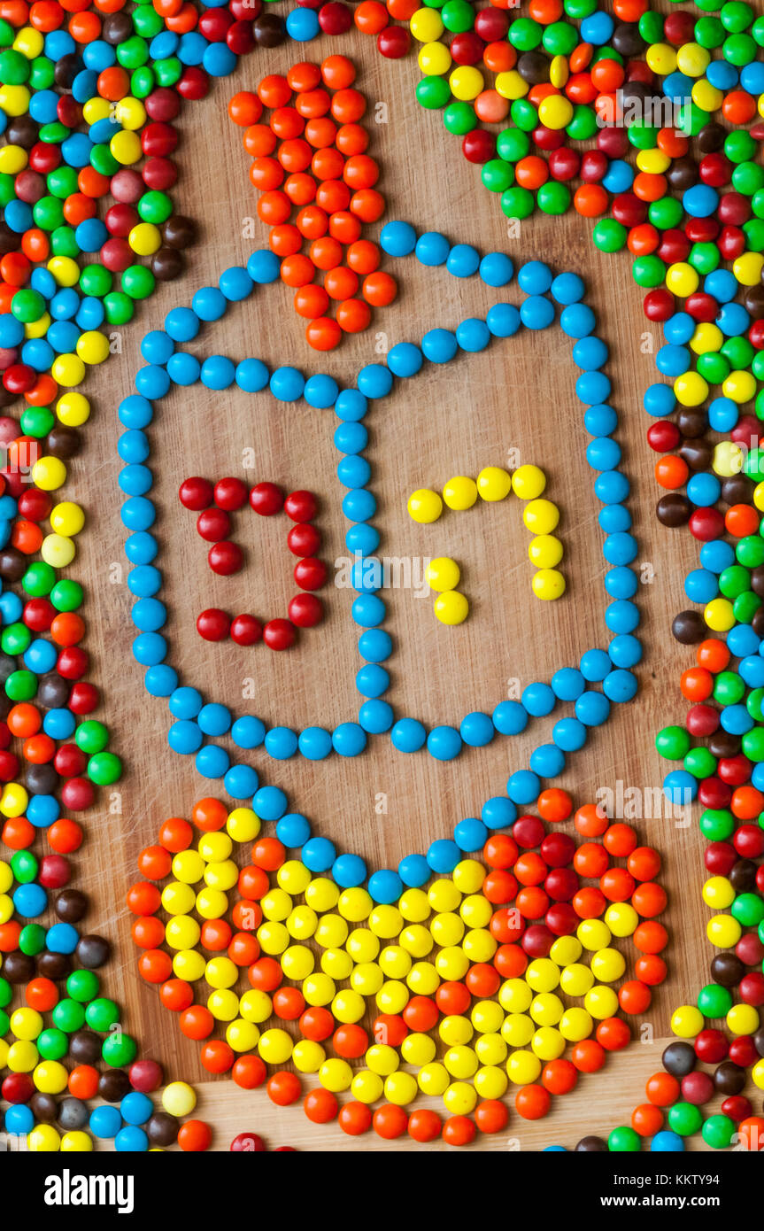 Hanukkah spinning top/ dreidel made out of colorful round chocolate ...