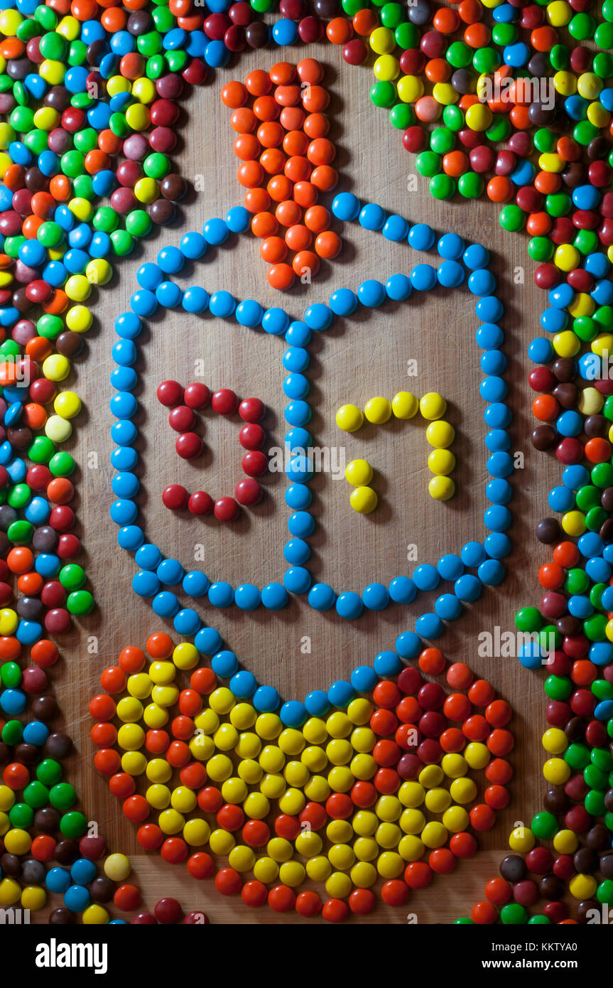 Hanukkah spinning top/ dreidel made out of colorful round chocolate ...