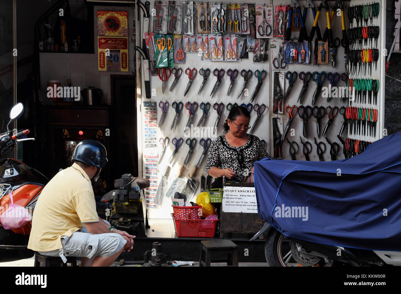 HO CHI MINH CITY, Woman working at front of scissors shop at Cho Lon ...