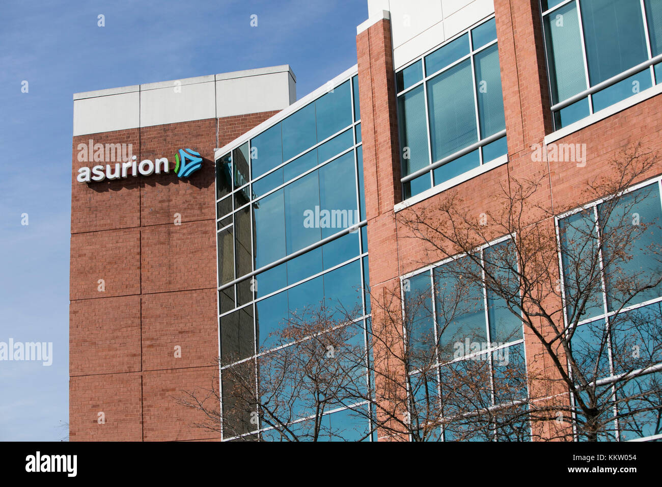 A logo sign outside of a facility occupied by Asurion in Sterling ...