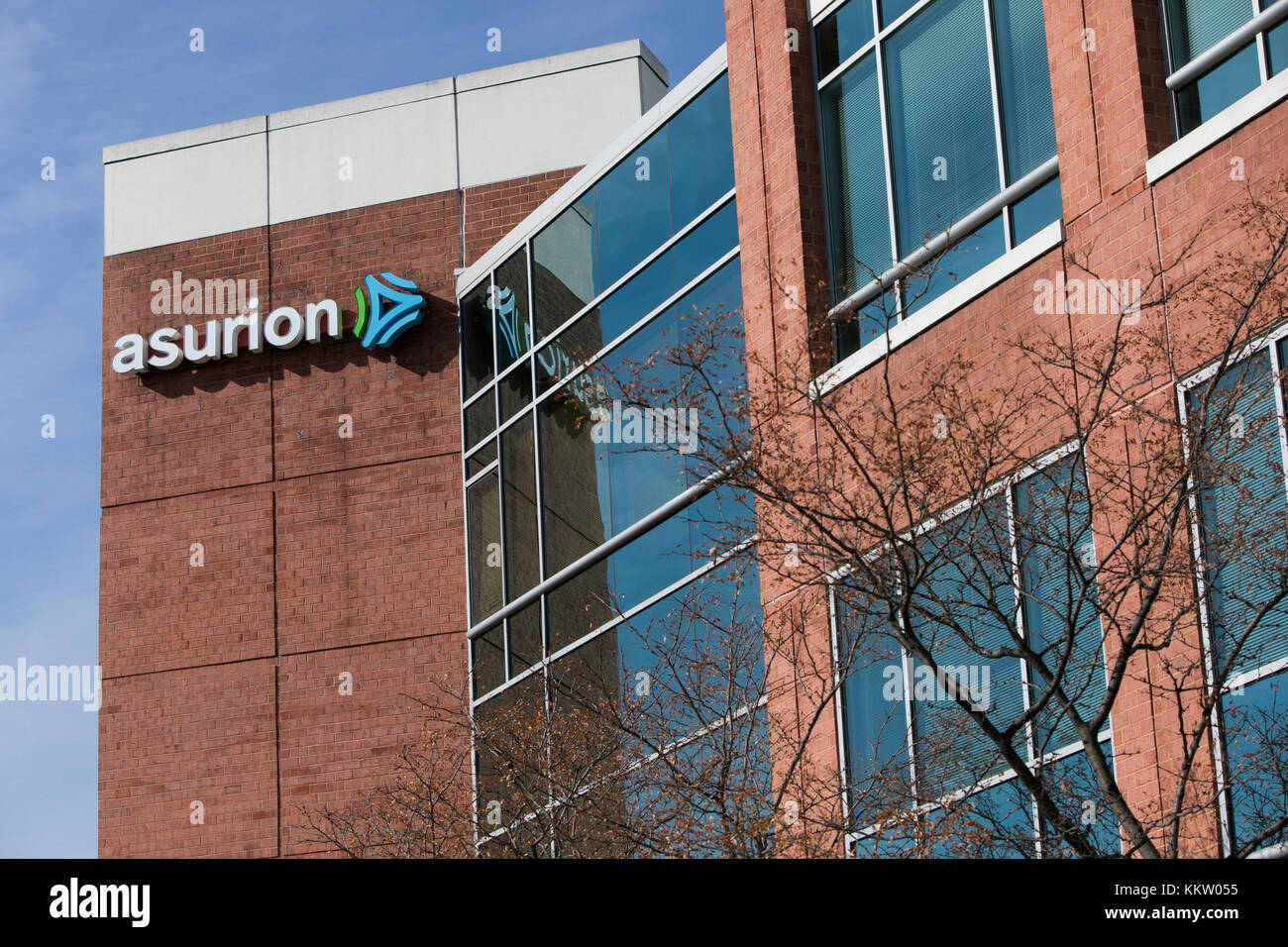 A logo sign outside of a facility occupied by Asurion in Sterling ...