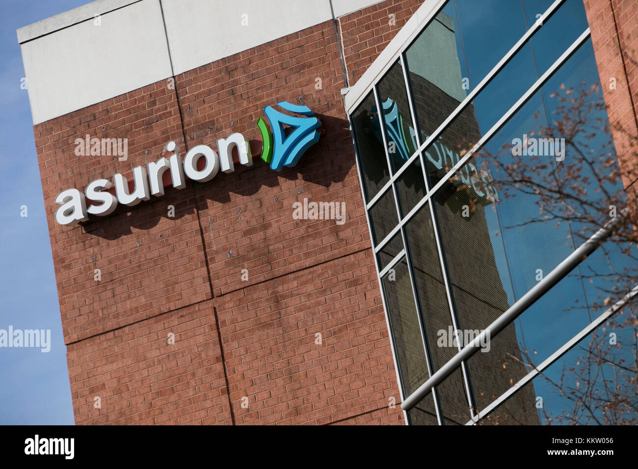A logo sign outside of a facility occupied by Asurion in Sterling ...