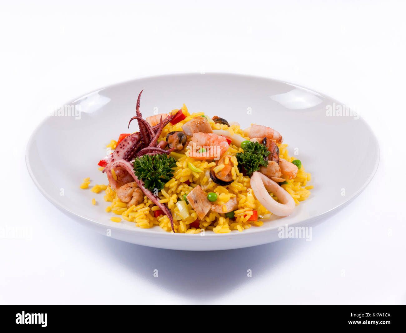 Seafood risotto in plsyr on white background Stock Photo - Alamy