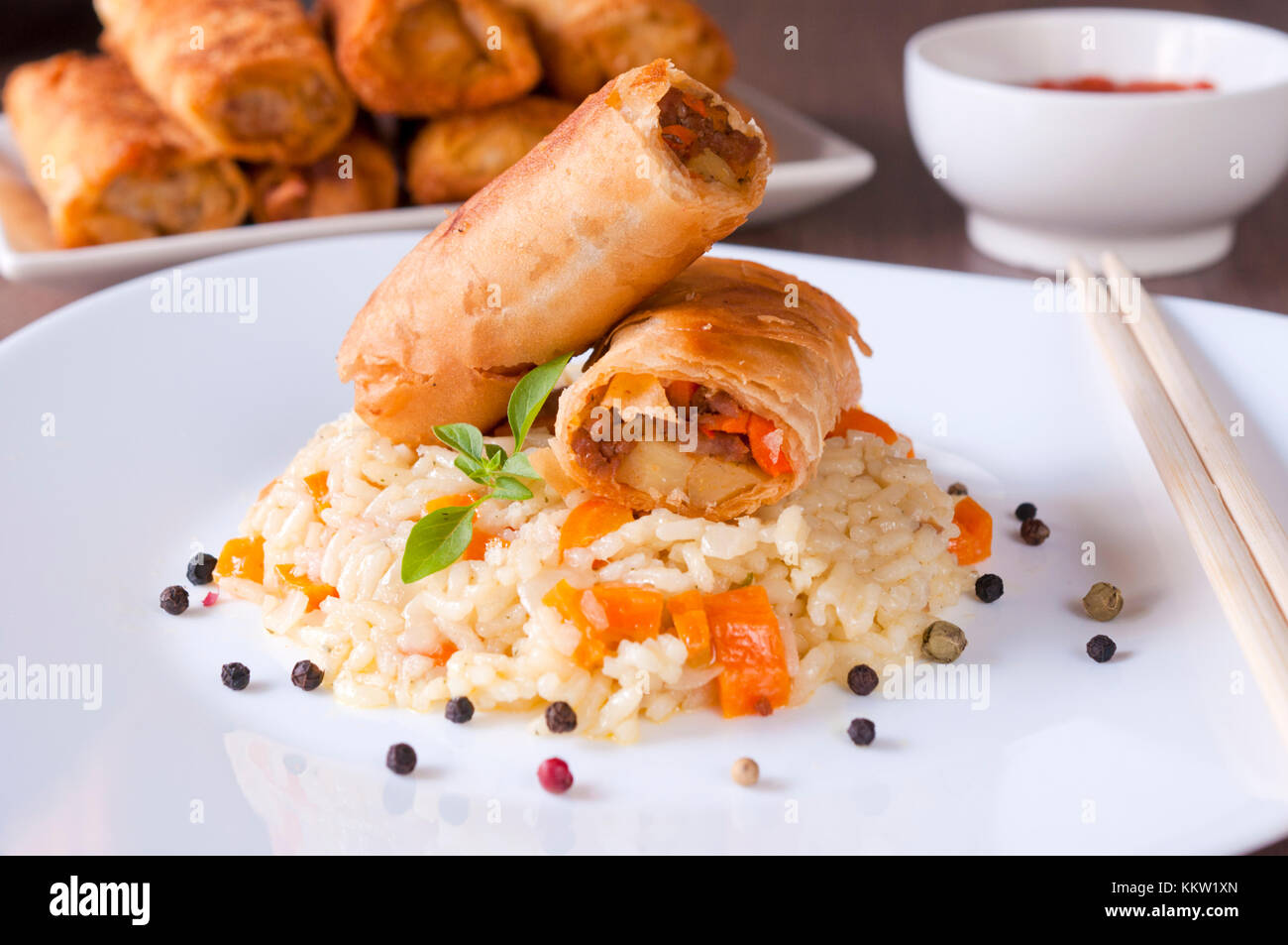 Spring rolls with meat and white rice on the plate Stock Photo - Alamy