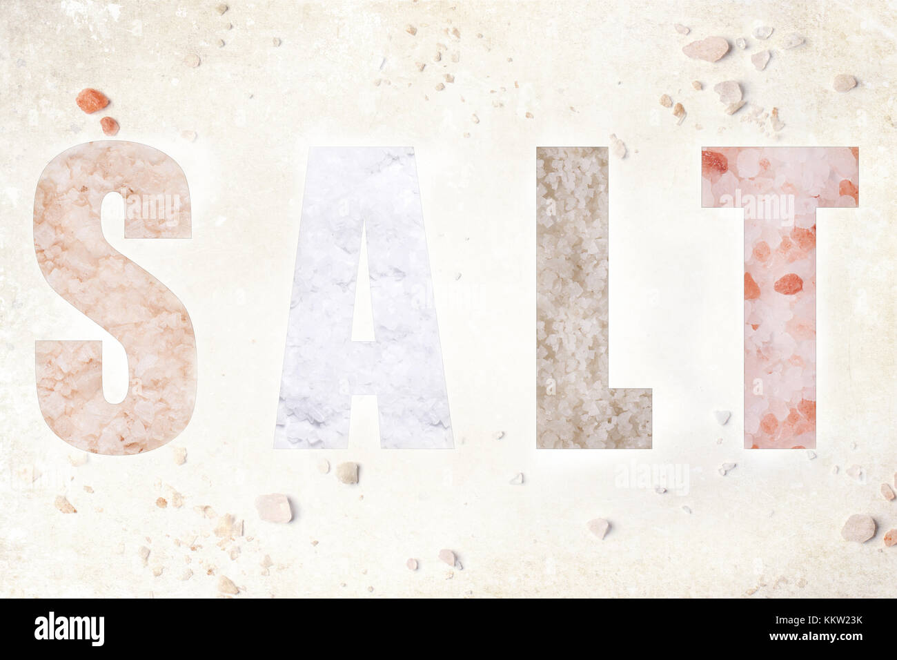 The word salt with mix of four kind of salts over textured background ...