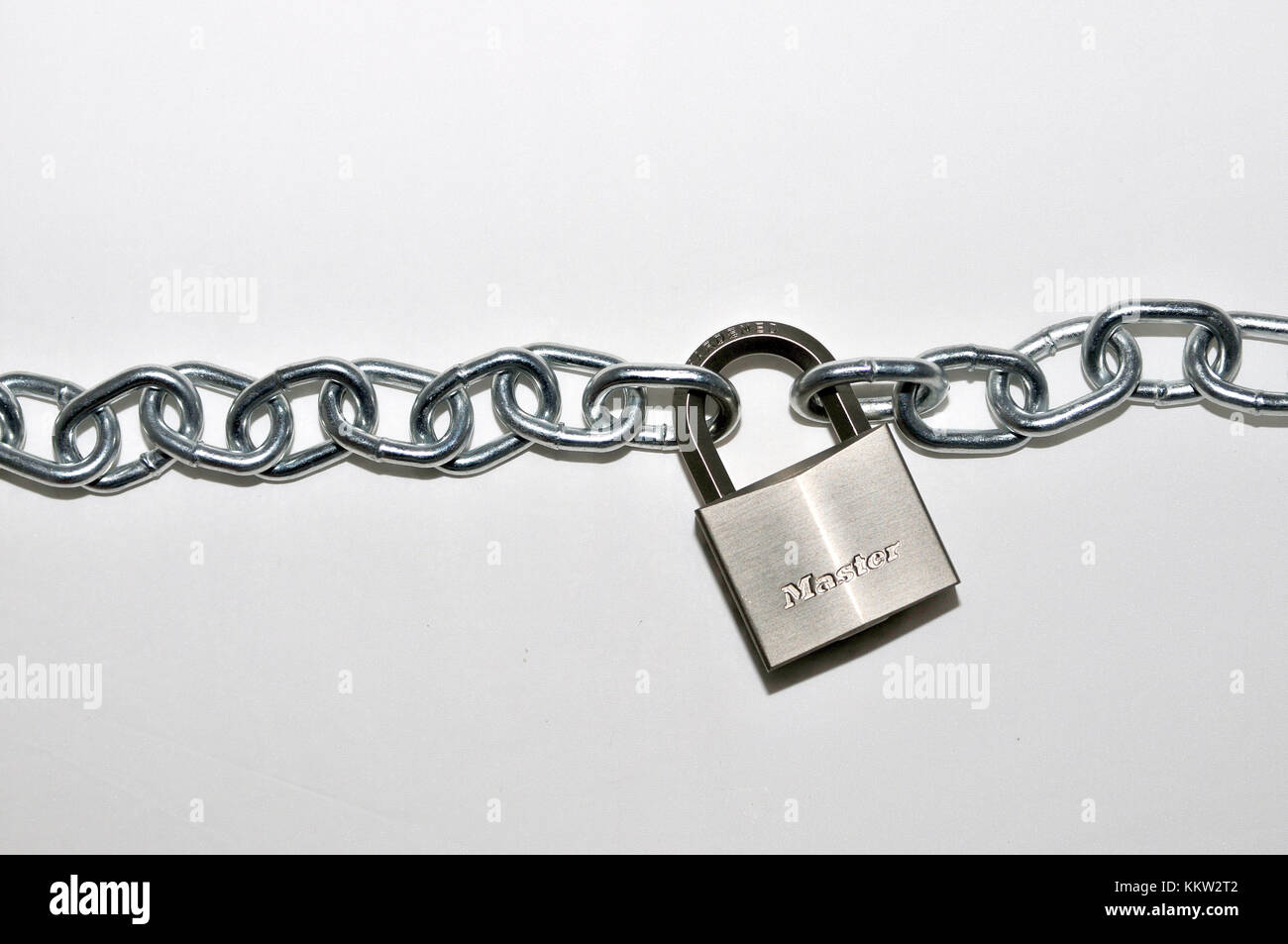 A padlock on a chain linking tow ends of a chain together for locking ...