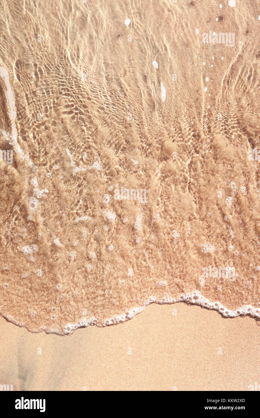Transparent soft wave on sandy beach Stock Photo - Alamy