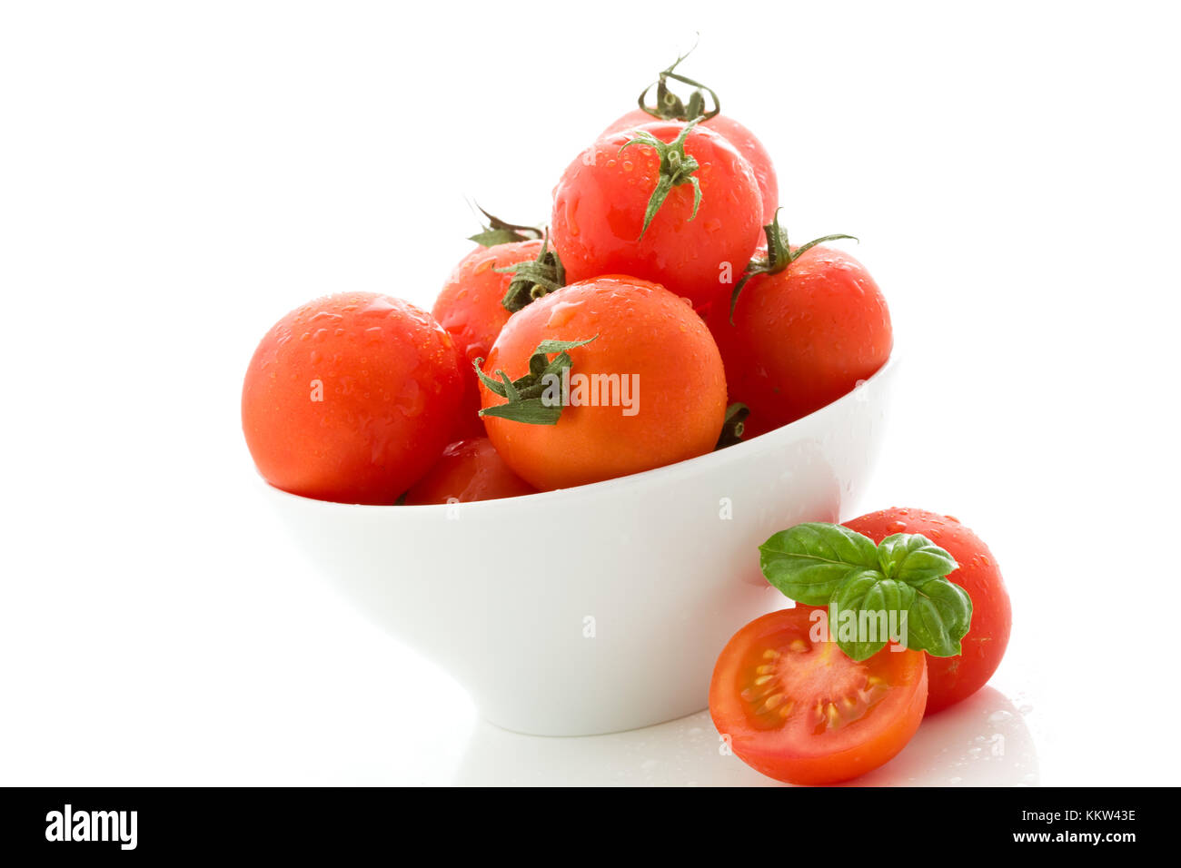 photo of delicious tomatoes inside a bowl on white isolated background ...