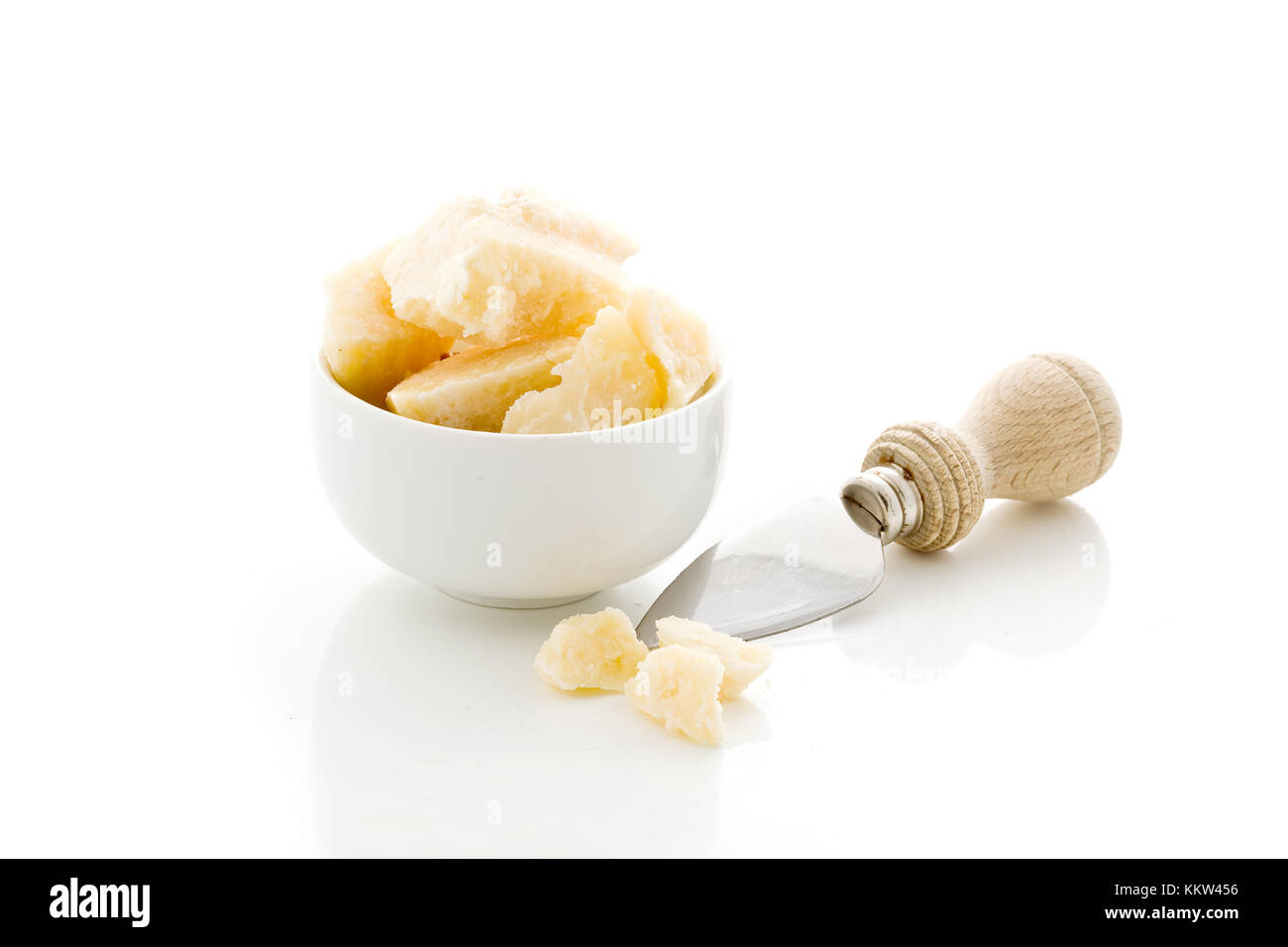 italian parmesan inside a bowl with knife on white isolated background ...