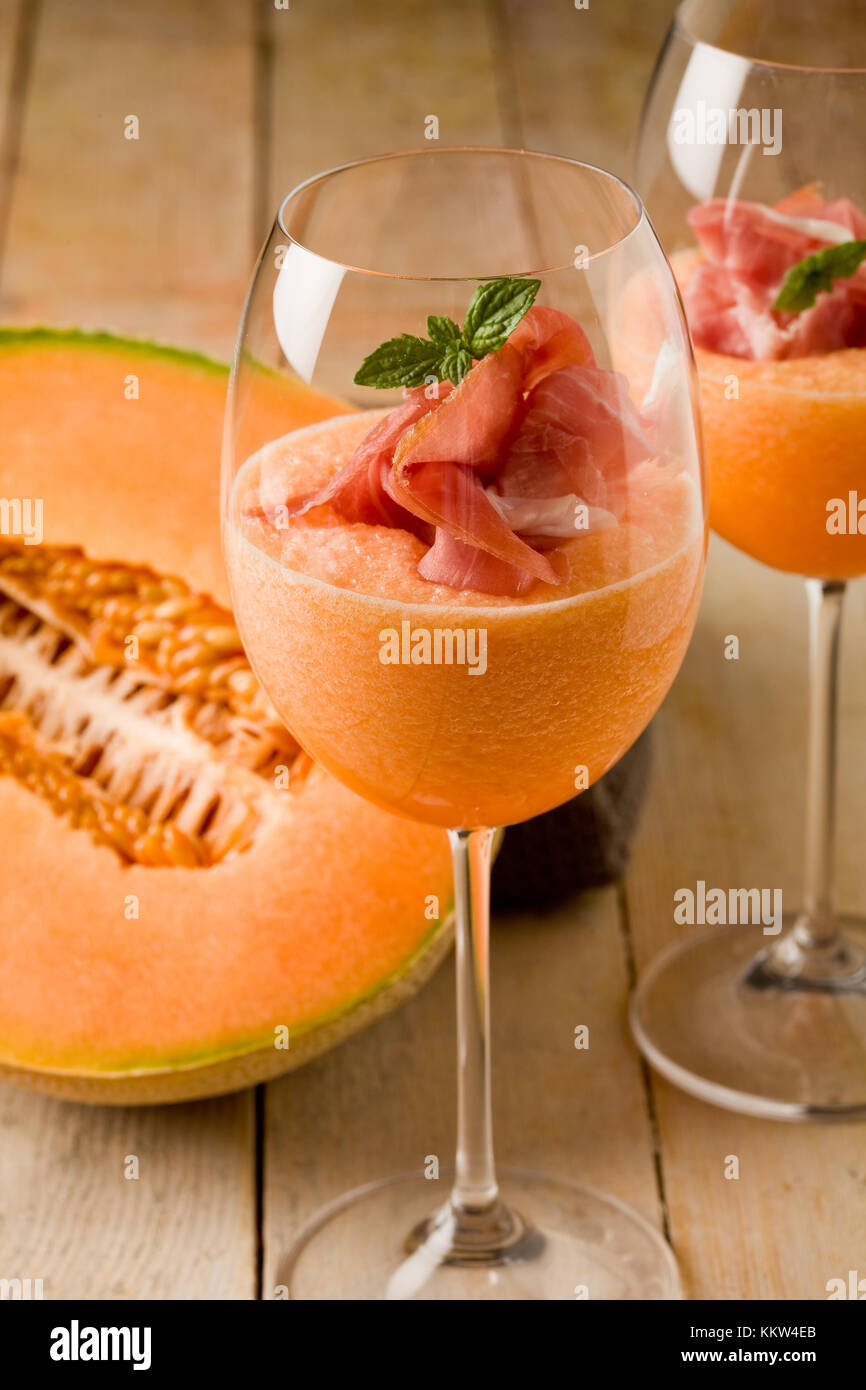 photo of delicious ham and melon cocktail appetizer on wooden table ...