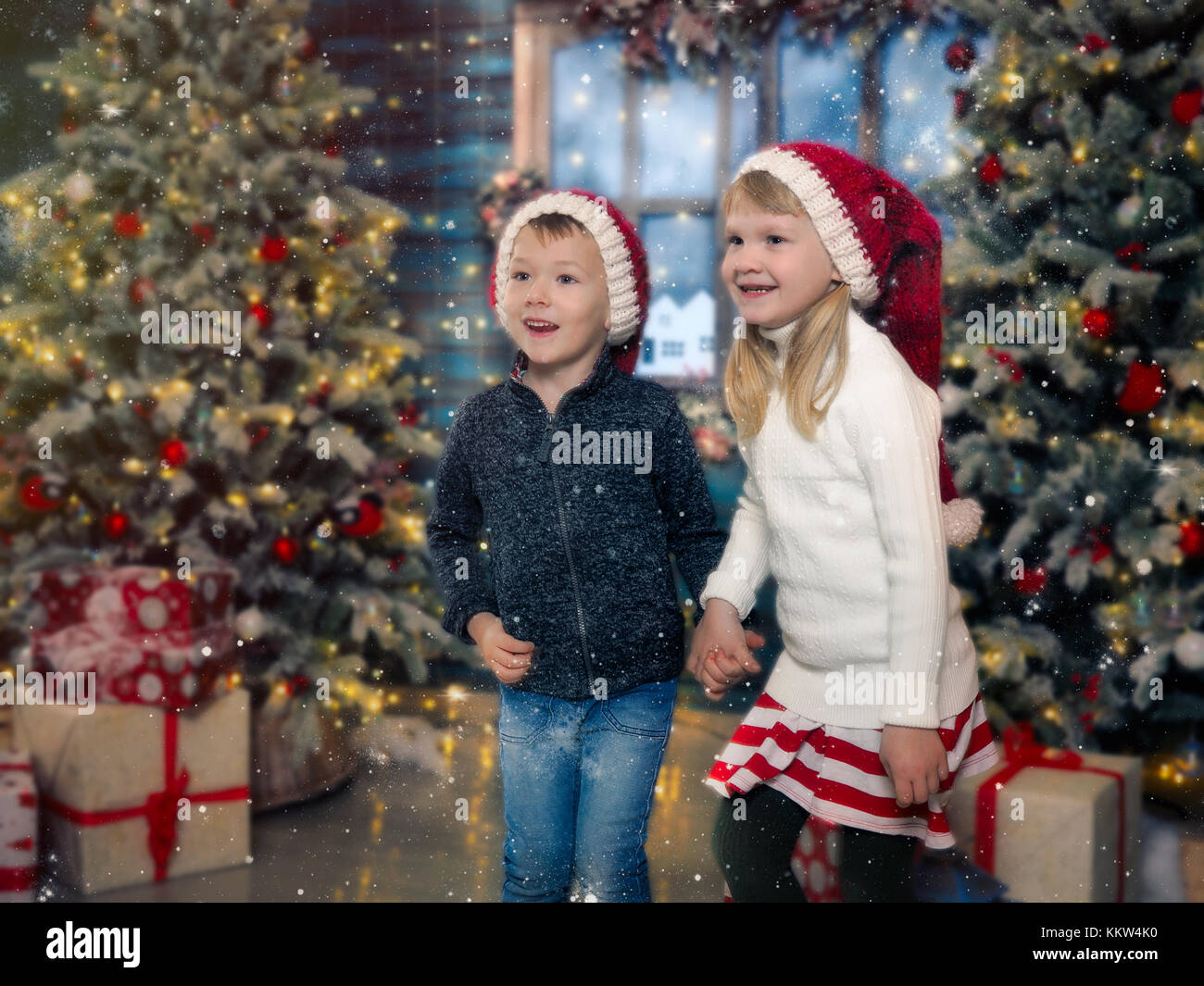 Happy children beside Christmas trees. Emotional portrait of a brother ...