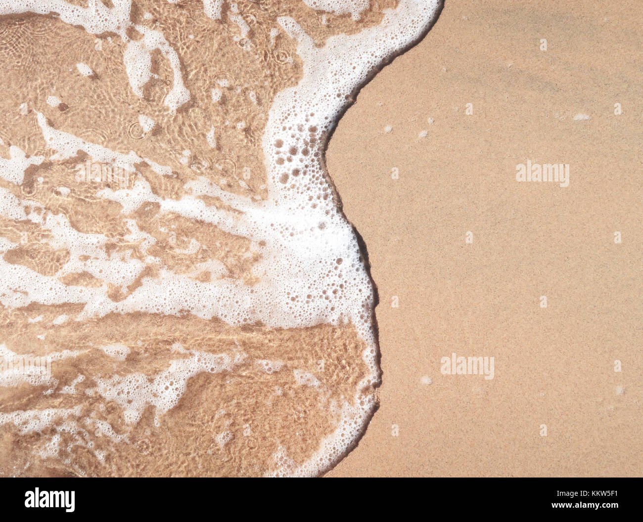 Transparent soft wave on sandy beach Stock Photo - Alamy
