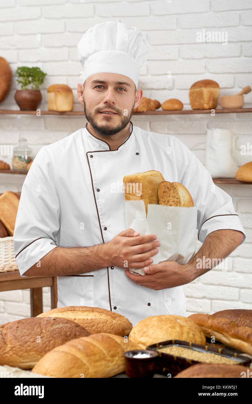 Young man working at his bakery Stock Photo - Alamy
