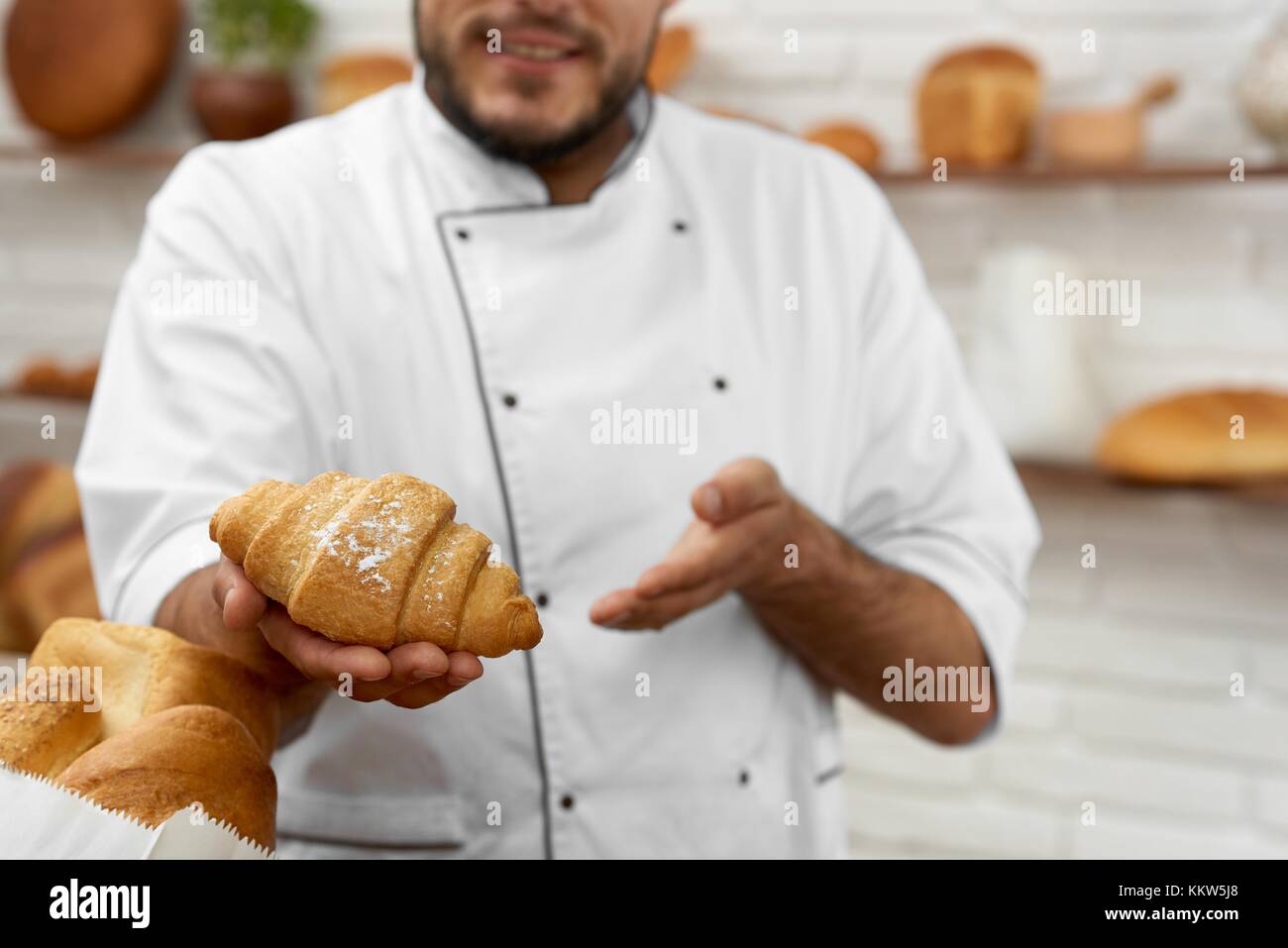 Young man working at his bakery Stock Photo - Alamy
