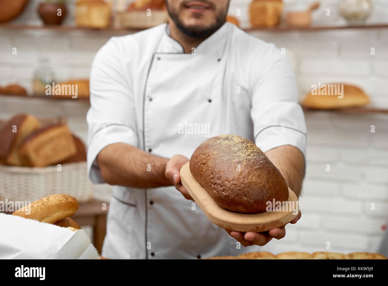 Young man working at his bakery Stock Photo - Alamy