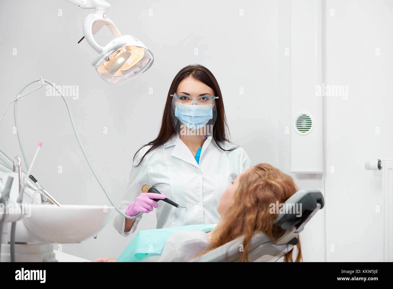Professional female dentist at work Stock Photo - Alamy