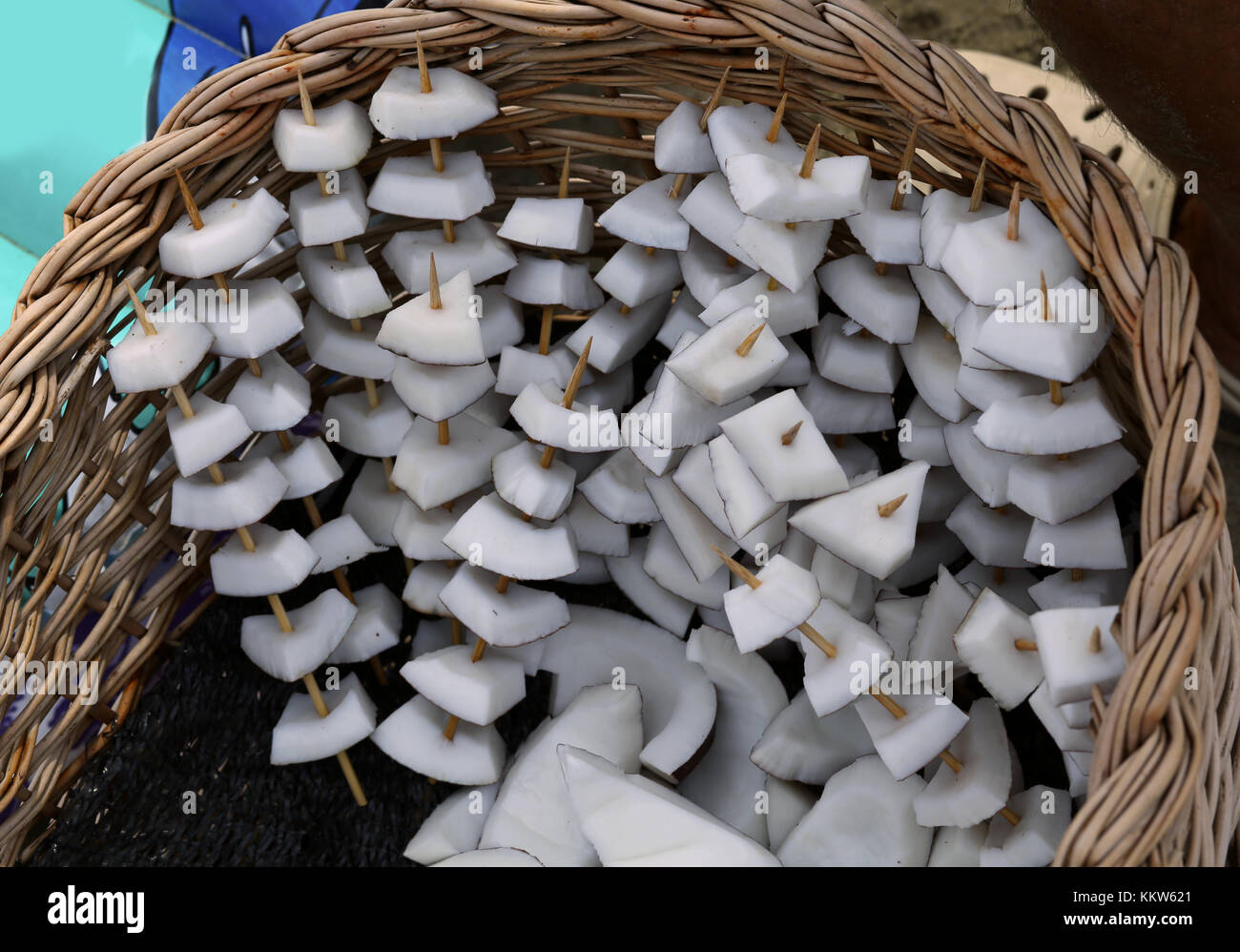 basket with lots of slices of fresh coconut for sale on the beach in ...
