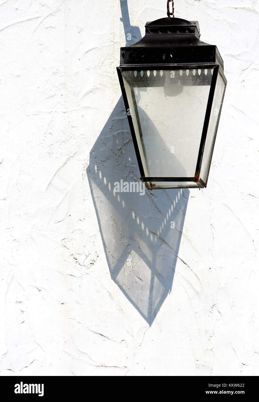 lamp with glass and the shadow on the wall of the Mediterranean house ...