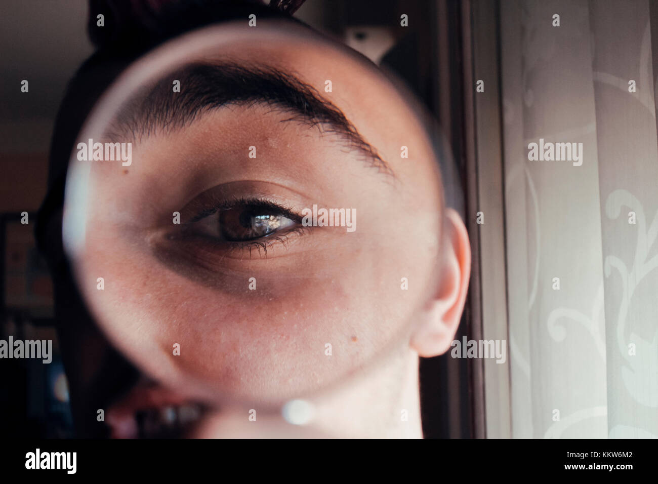 An eye through a magnifying glass Stock Photo - Alamy