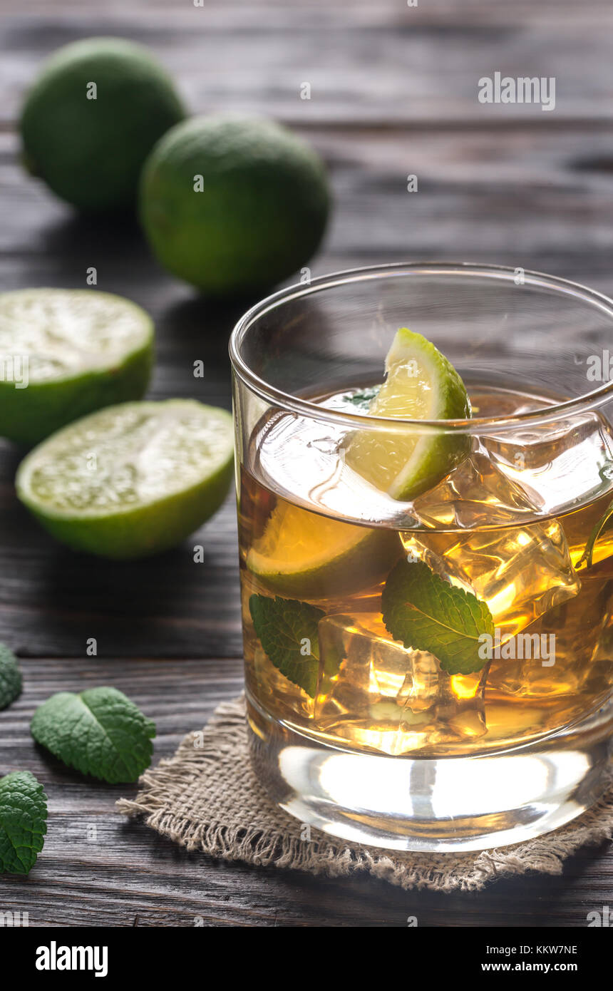 Glass of rum on the wooden background Stock Photo - Alamy