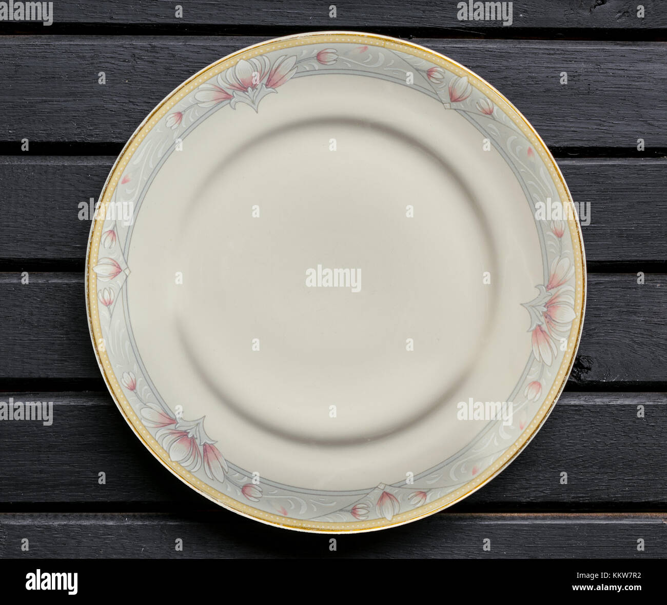 Porcelain or ceramic white plate, ordinary, with unique rose flower ...