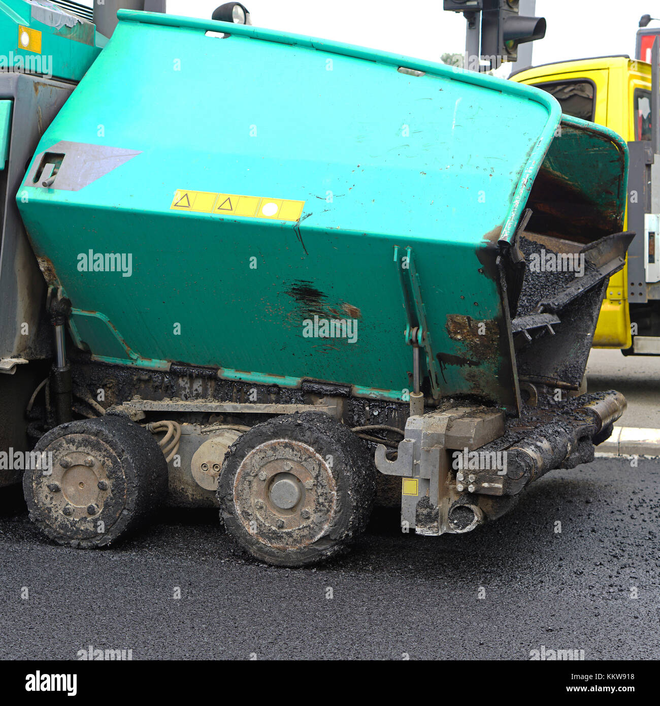 Asphalting works surfacing road machine Stock Photo - Alamy