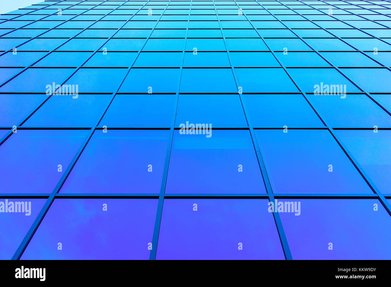 Windows of modern futuristic glass skyscraper reflecting the blue sky ...