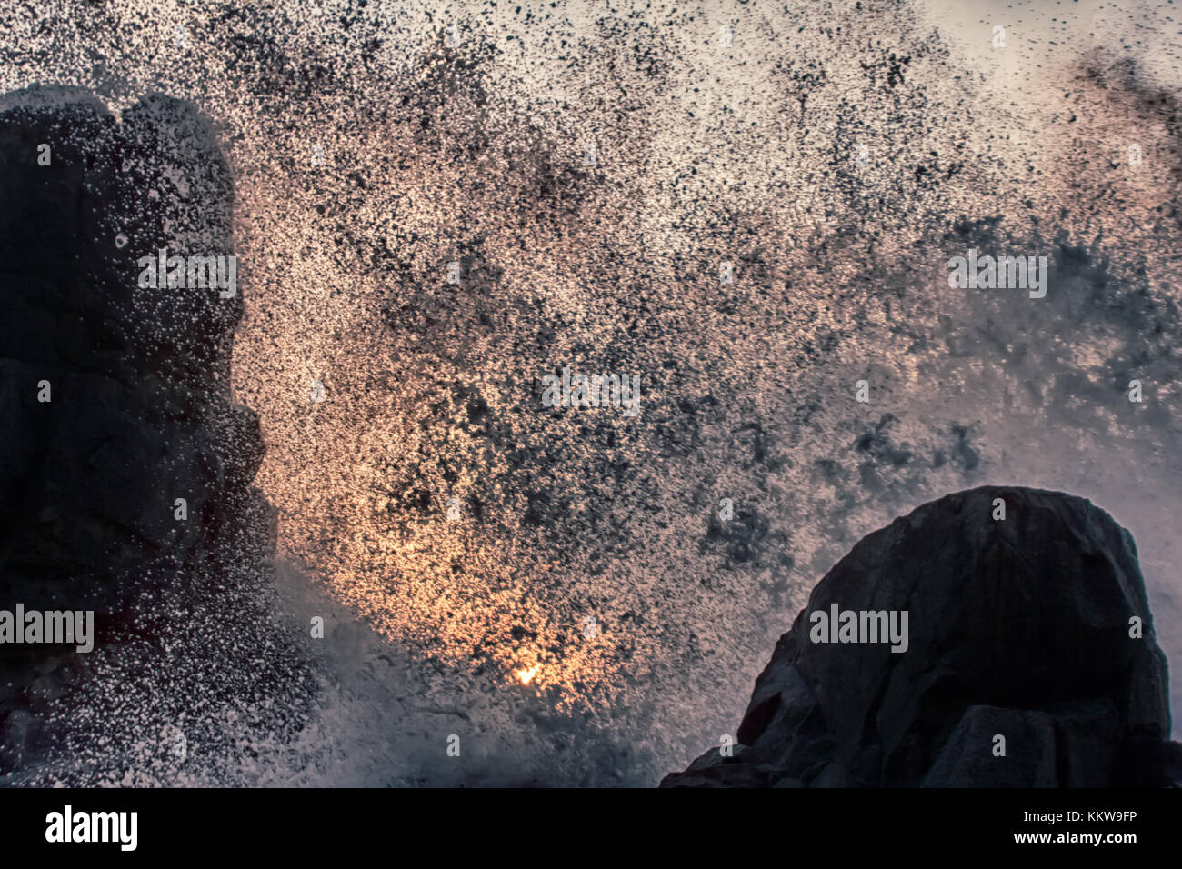 super bright storm at sunset provided sharp rocks of ocean. water ...